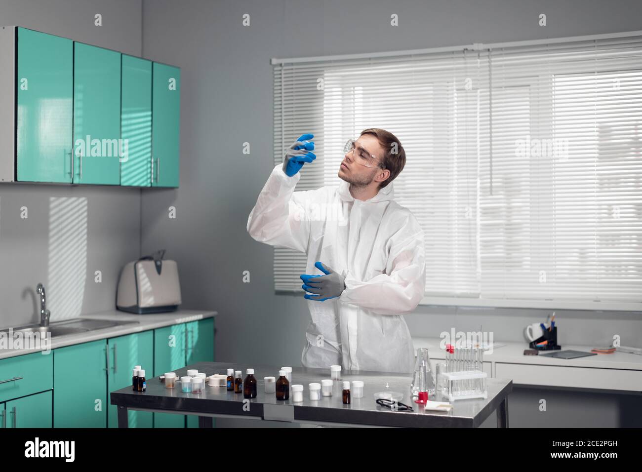A young man conducting an experiment in a scientific laboratory Stock ...