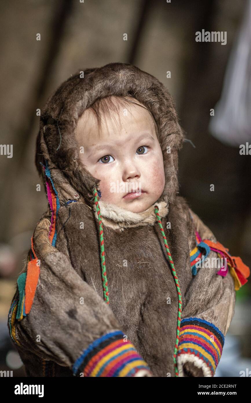 Portrait of a 2 years old Nenet child with traditional wear inside a ...