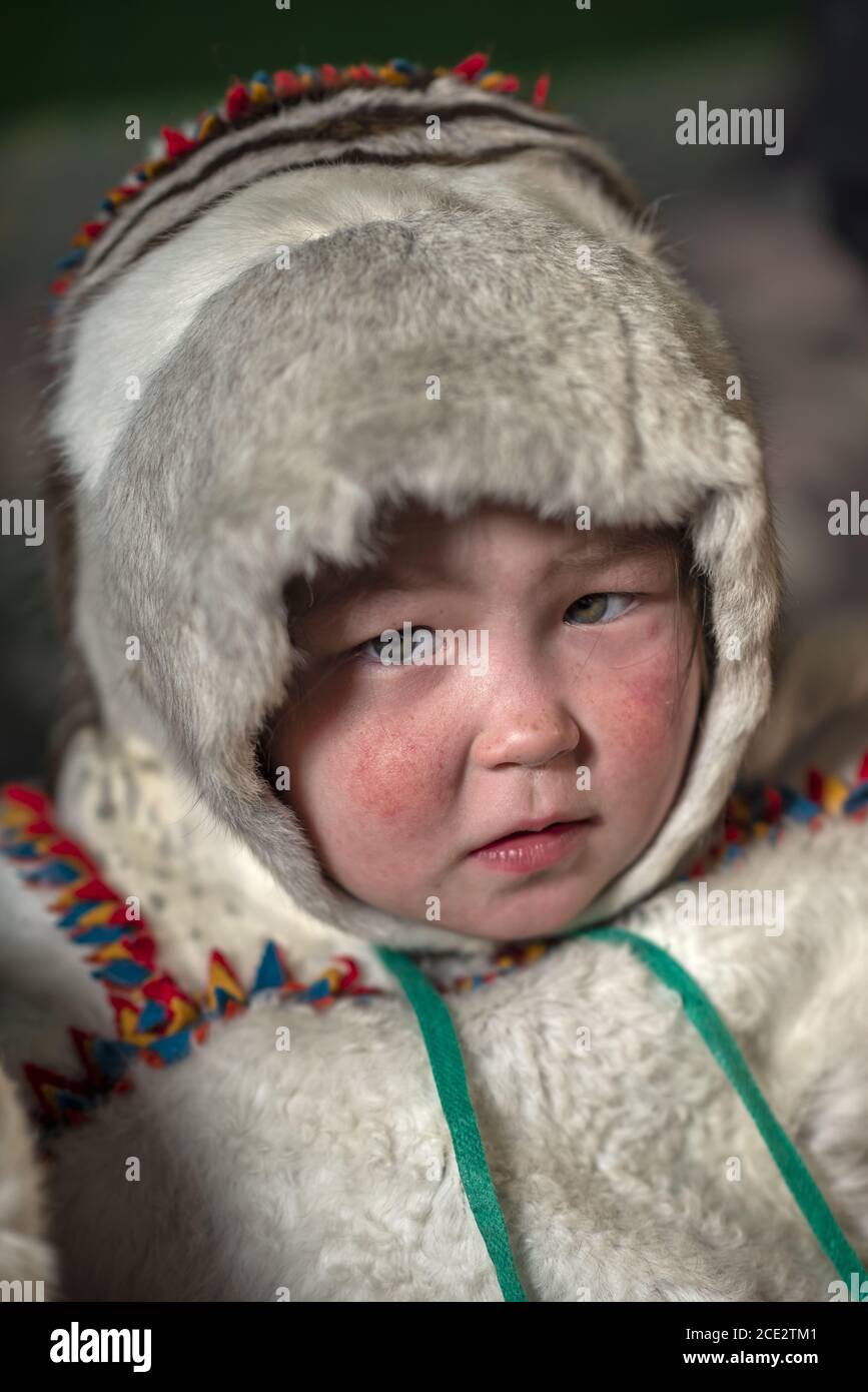Close-up portrait of a young Nenet girl with traditional wear, Yamalo ...