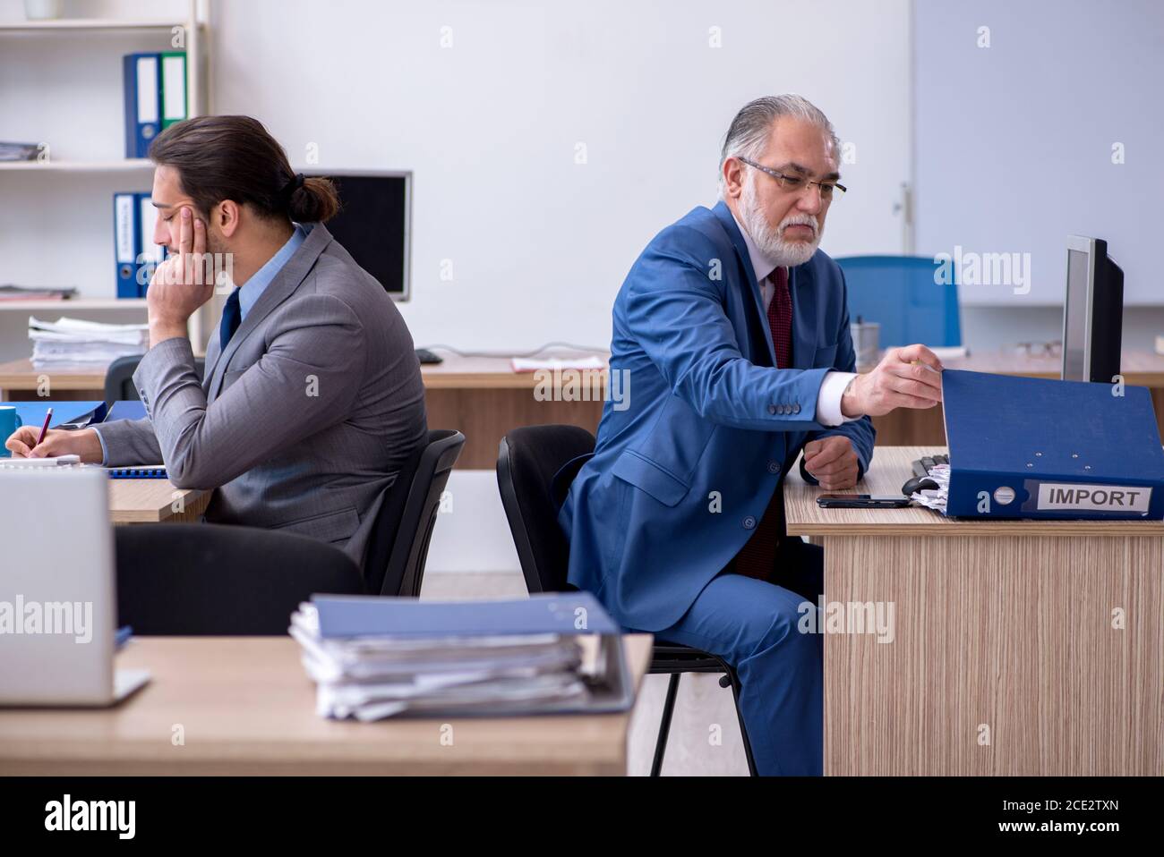 Two employees working in the office Stock Photo - Alamy