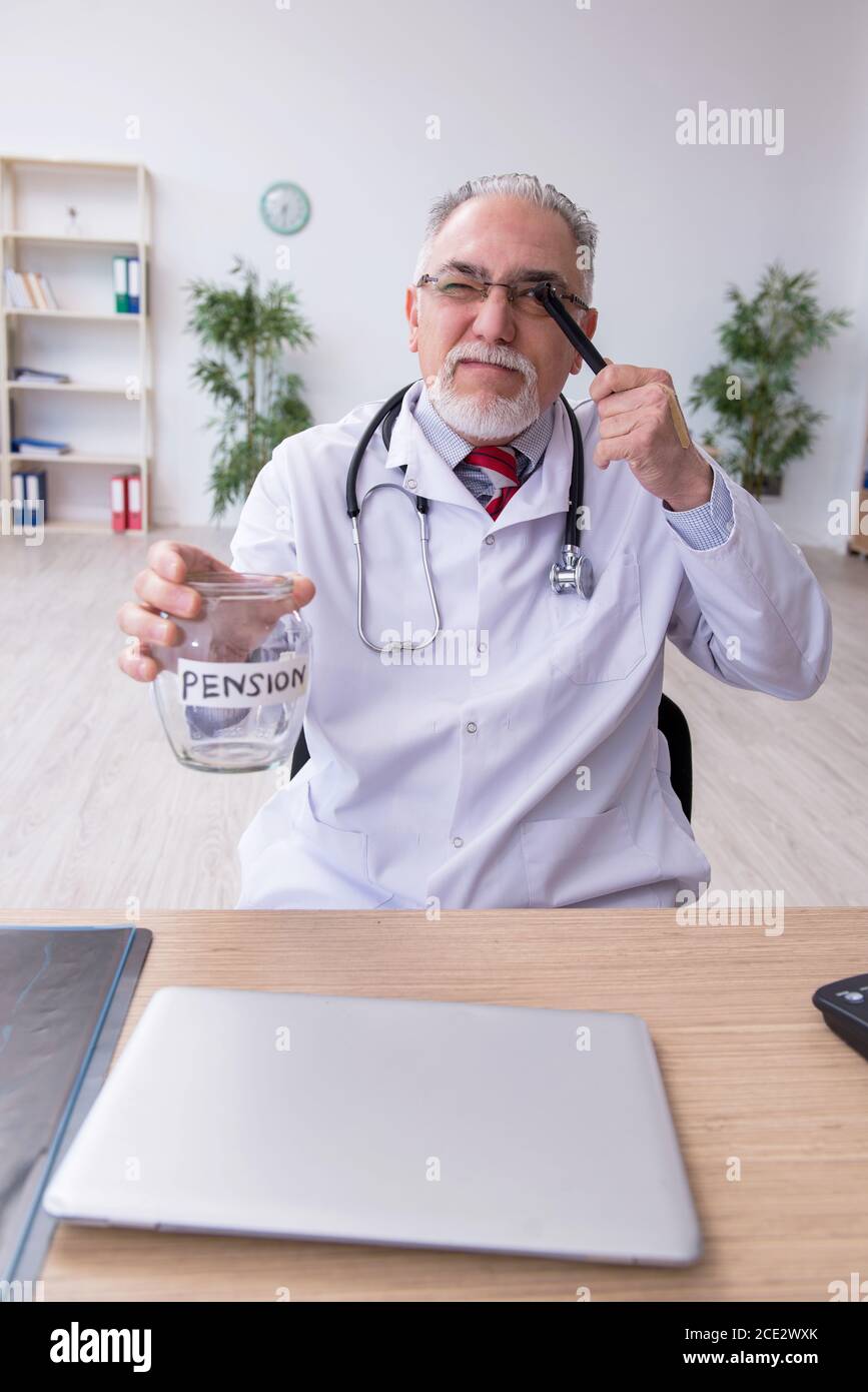 Old doctor in retirement concept Stock Photo - Alamy