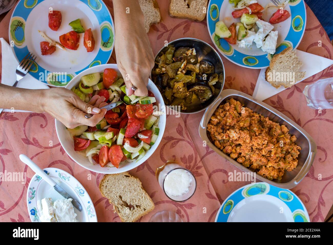 Top view of a Greek lunch meal at summer with omellete, horiatiki salad ...
