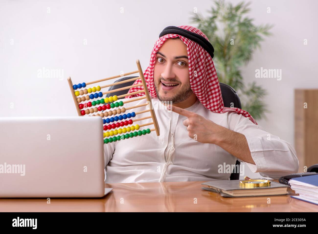 Male arab employee working in the office Stock Photo - Alamy