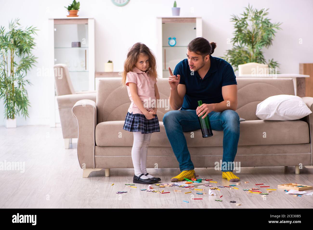 Drunk father and little girl at home Stock Photo - Alamy