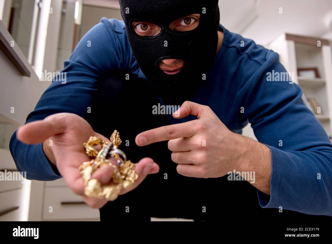 Robber stealing valuable things from the house Stock Photo - Alamy