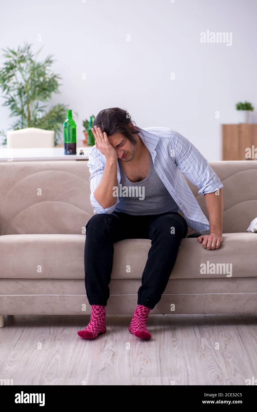 Male alcoholic drinking wine at home Stock Photo - Alamy