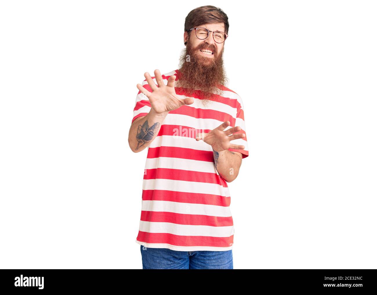 Handsome young red head man with long beard wearing casual clothes ...