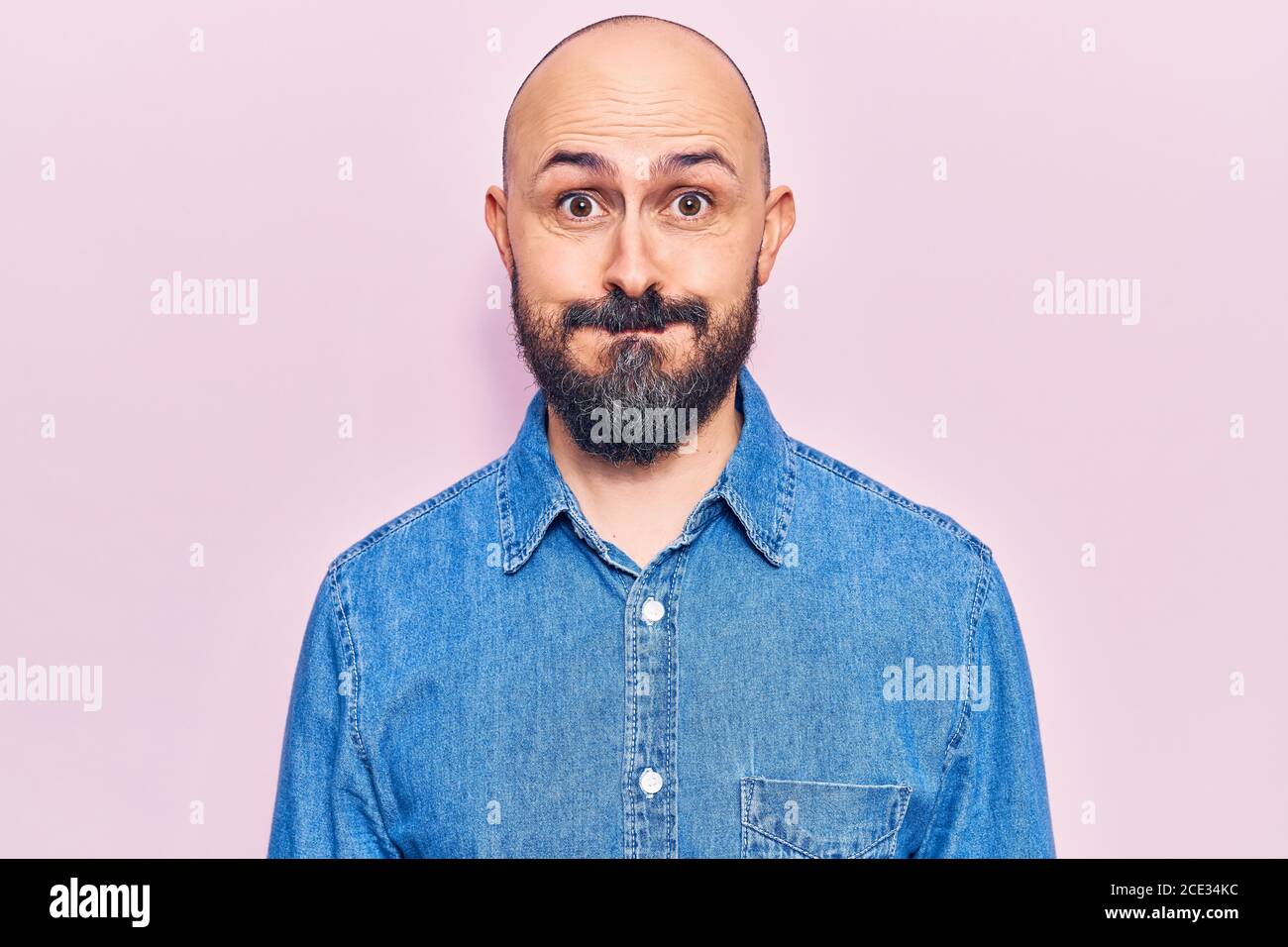Young handsome man wearing casual clothes puffing cheeks with funny ...