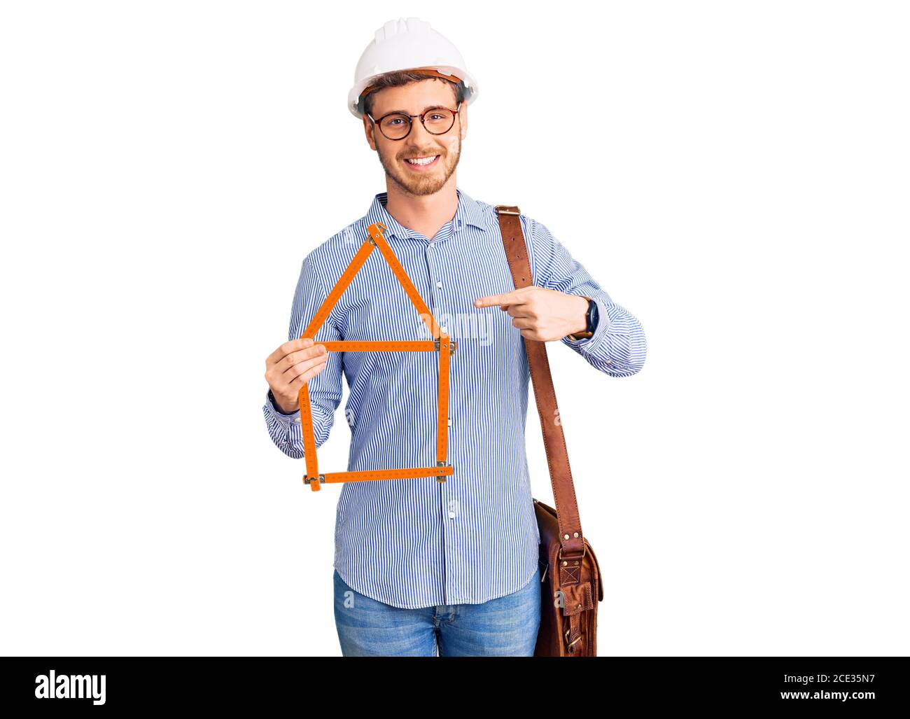 Handsome young man with bear wearing architect hardhat holding build ...