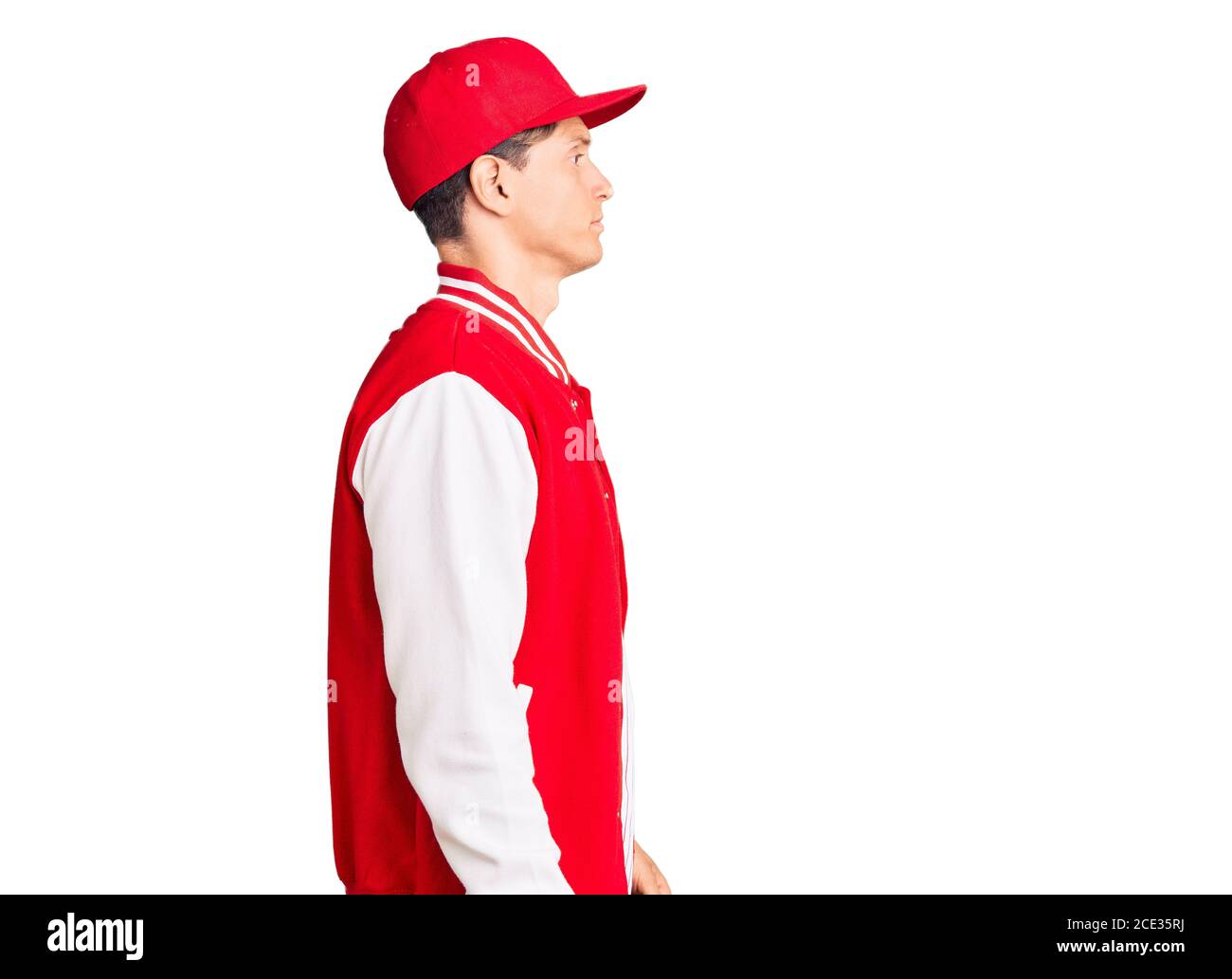 Young handsome man wearing baseball uniform looking to side, relax ...