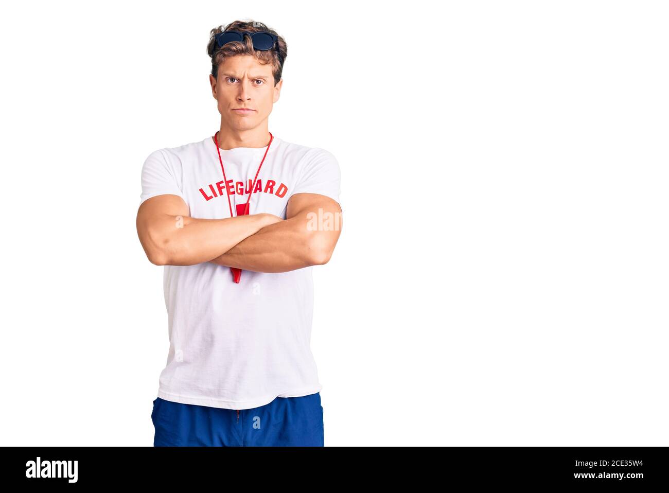Young handsome man wearing lifeguard t shirt and whistle skeptic and ...