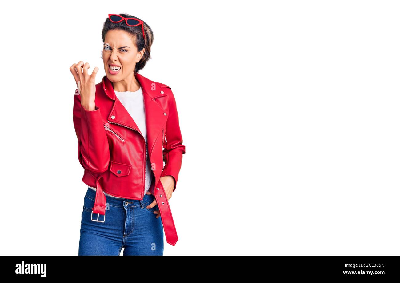 Young beautiful woman wearing red leather jacket angry and mad raising ...