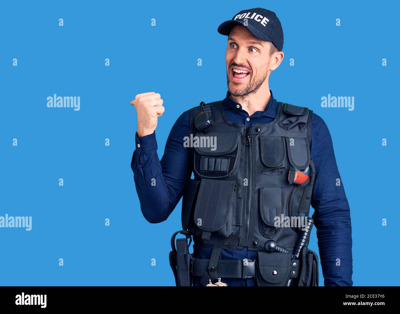 Young handsome man wearing police uniform smiling with happy face ...