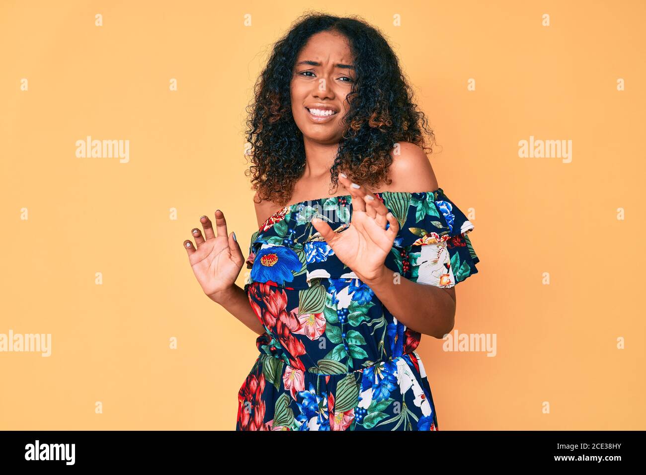 Young african american woman wearing casual clothes disgusted ...