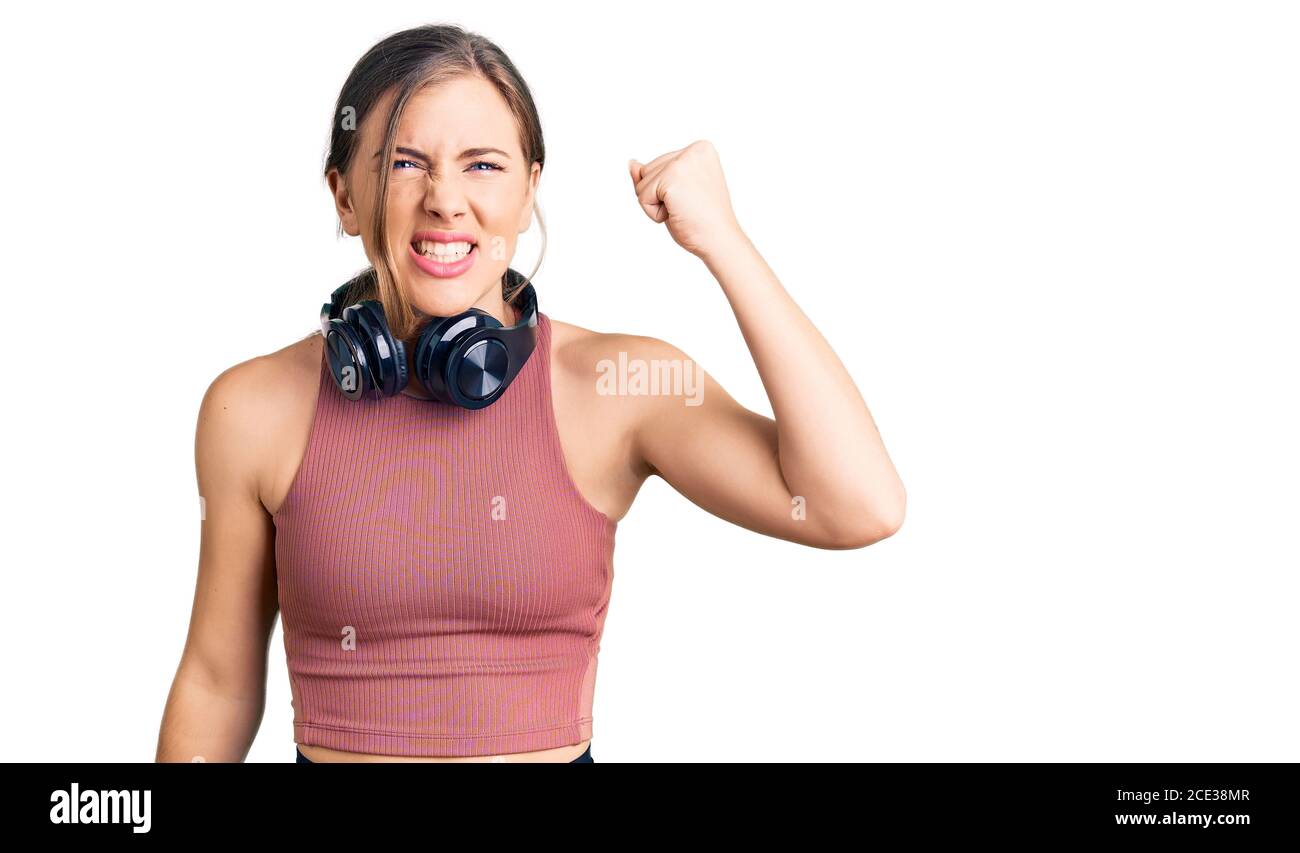 Beautiful caucasian young woman wearing gym clothes and using ...