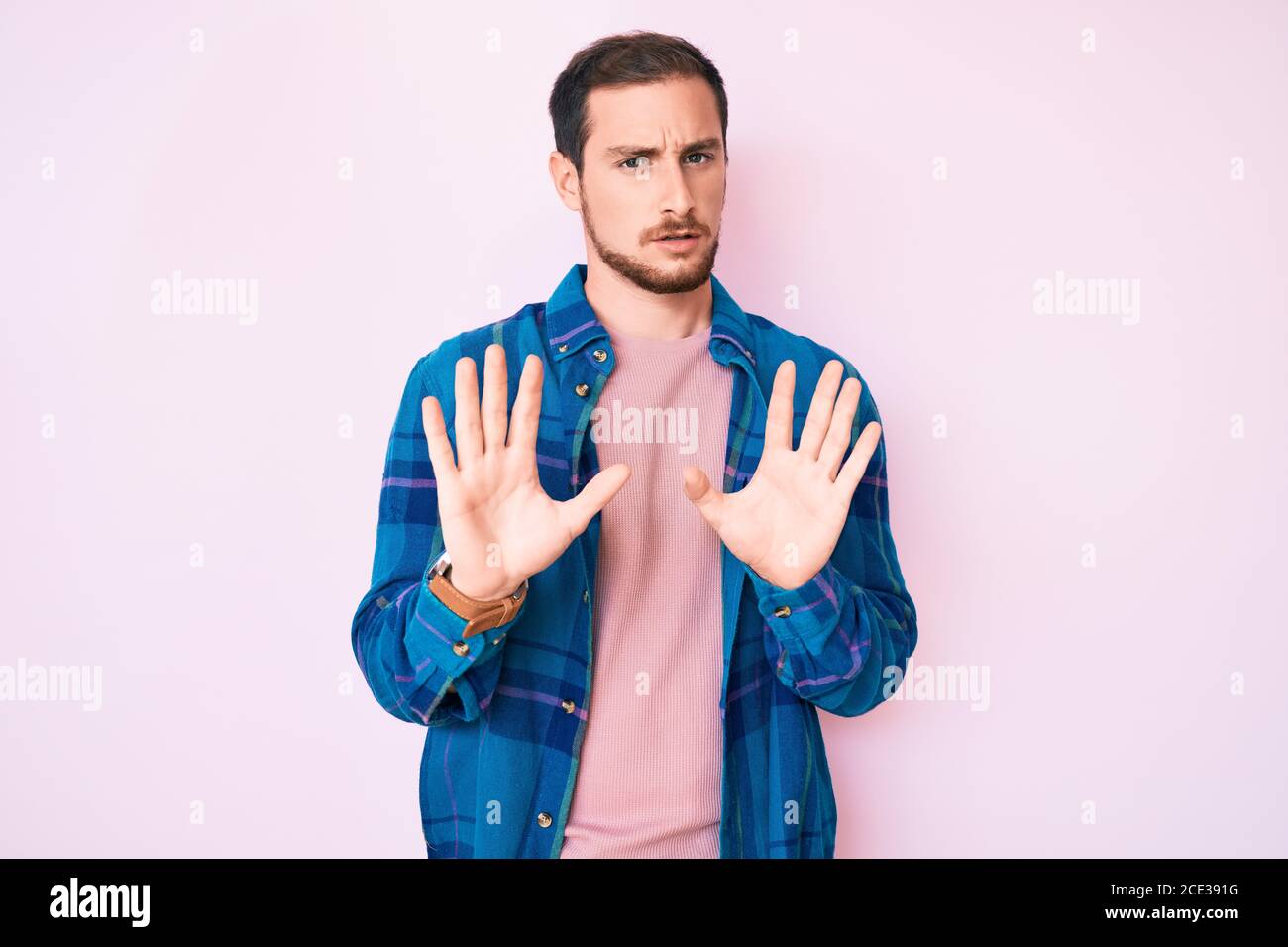 Young handsome man wearing casual clothes moving away hands palms ...