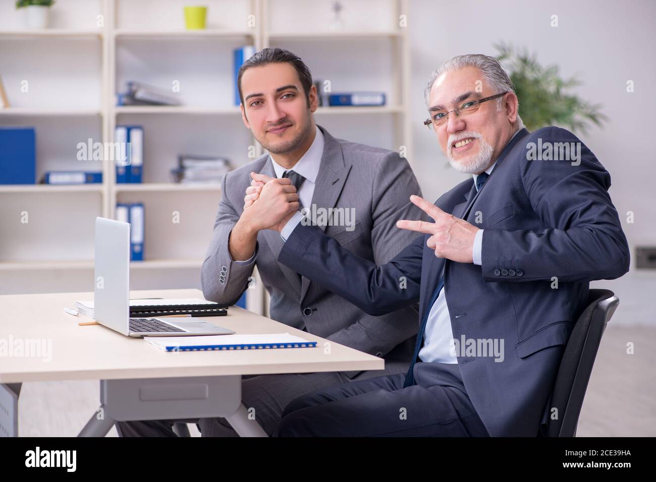 Old and young businessmen in the business meeting concept Stock Photo ...
