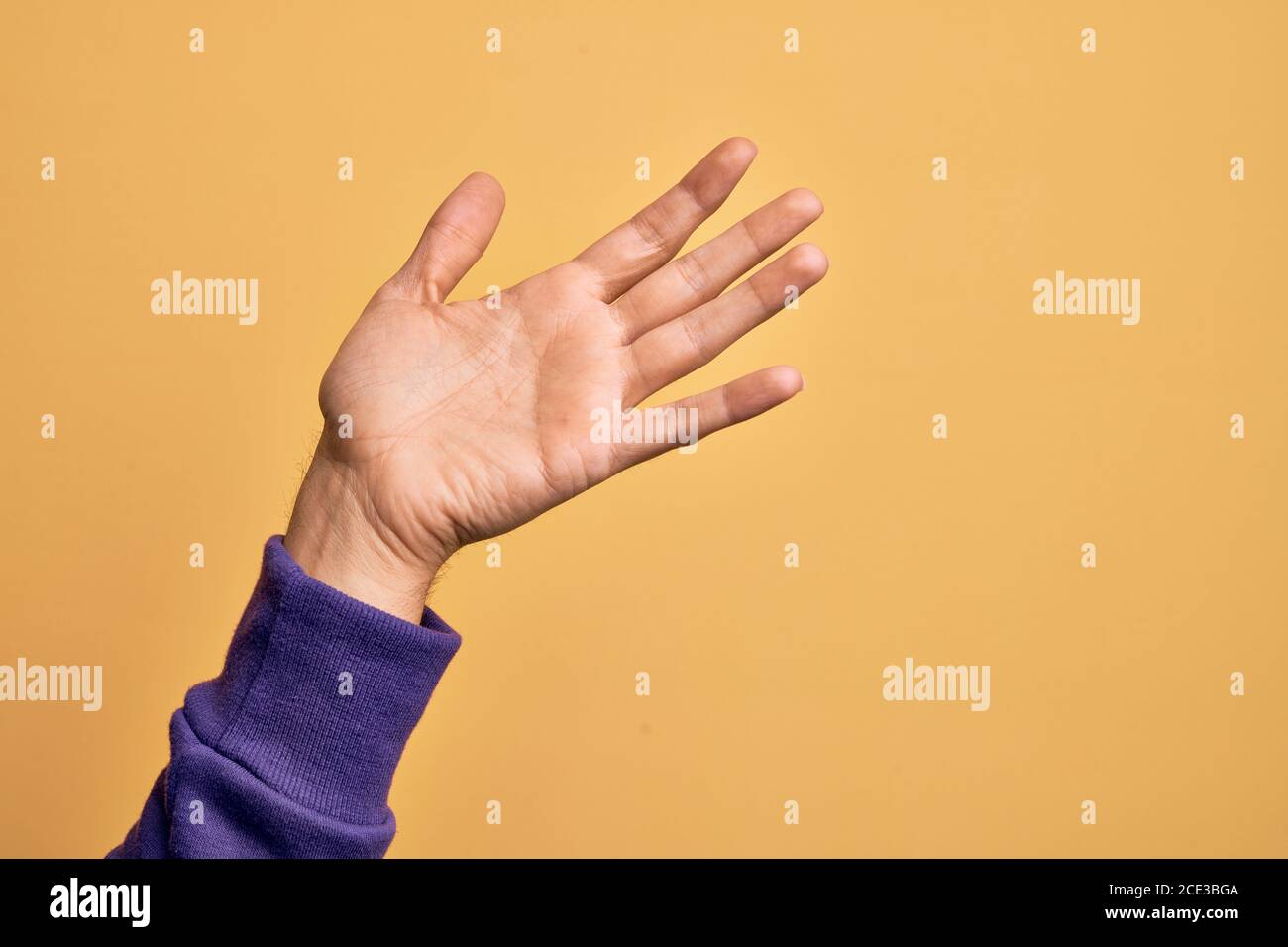Hand of caucasian young man showing fingers over isolated yellow ...