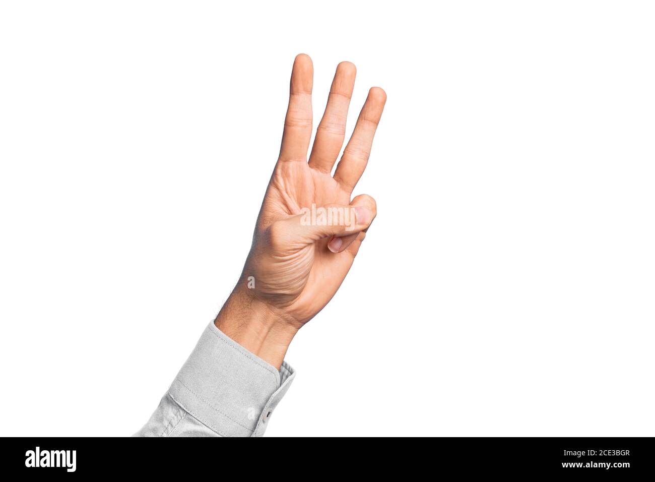 Hand of caucasian young man showing fingers over isolated white background counting number 3 ...