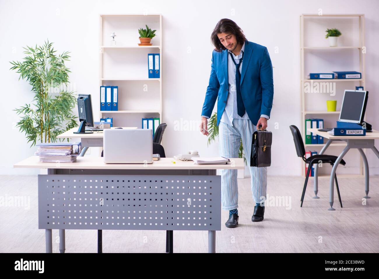 Male employee coming to work straight from the bed Stock Photo - Alamy