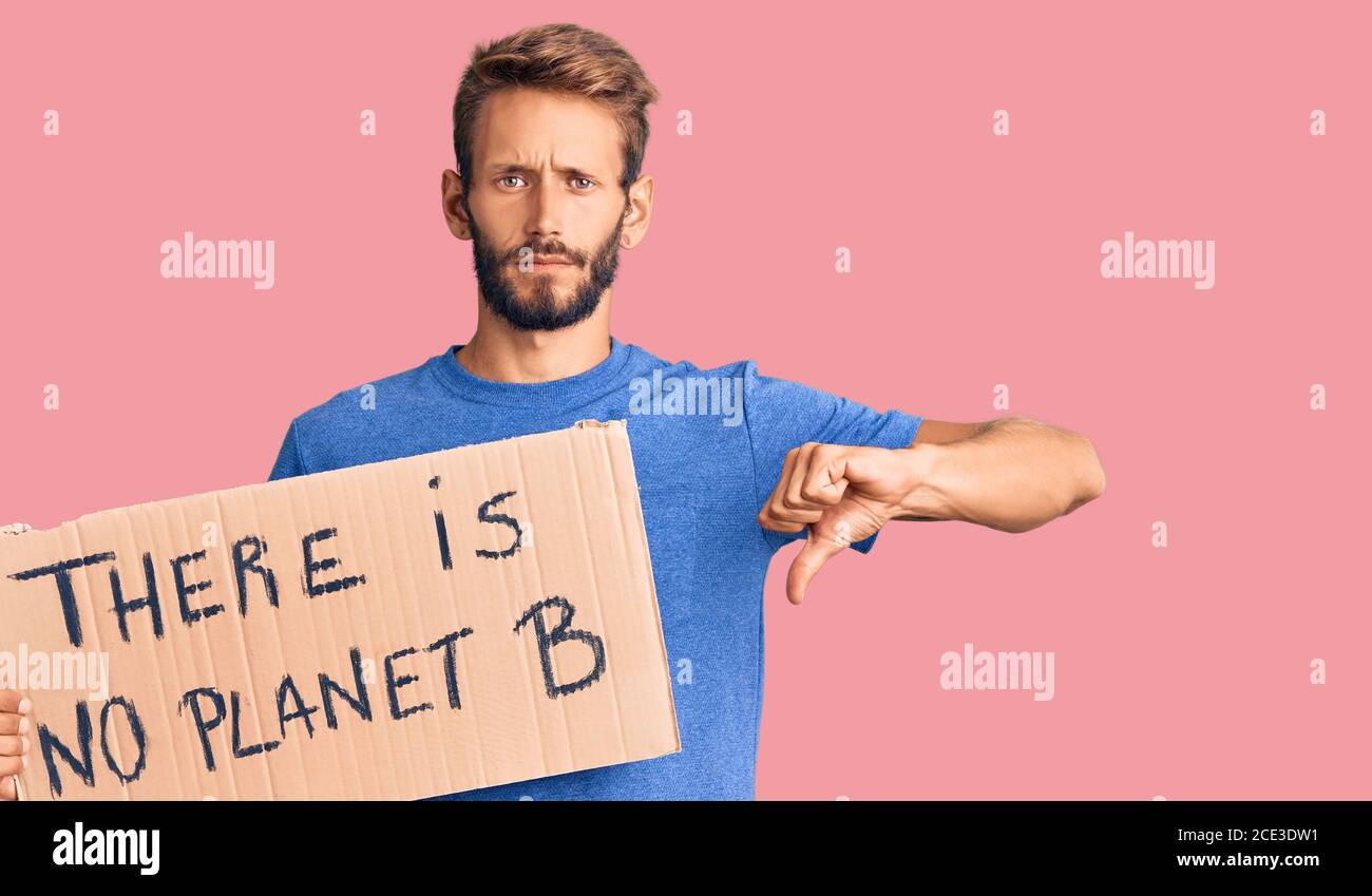 Handsome blond man with beard holding there is no planet b banner with ...