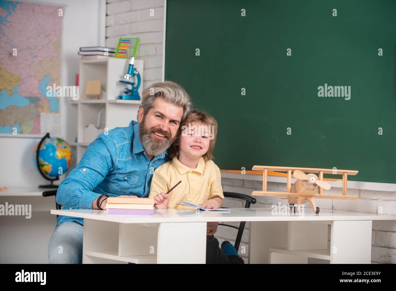 Father teaching son. Funny little child with father having fun on ...