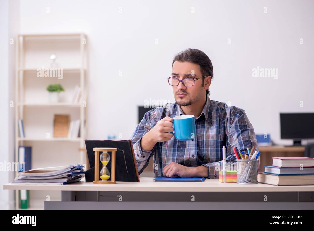 Young student sitting in the classroom Stock Photo - Alamy