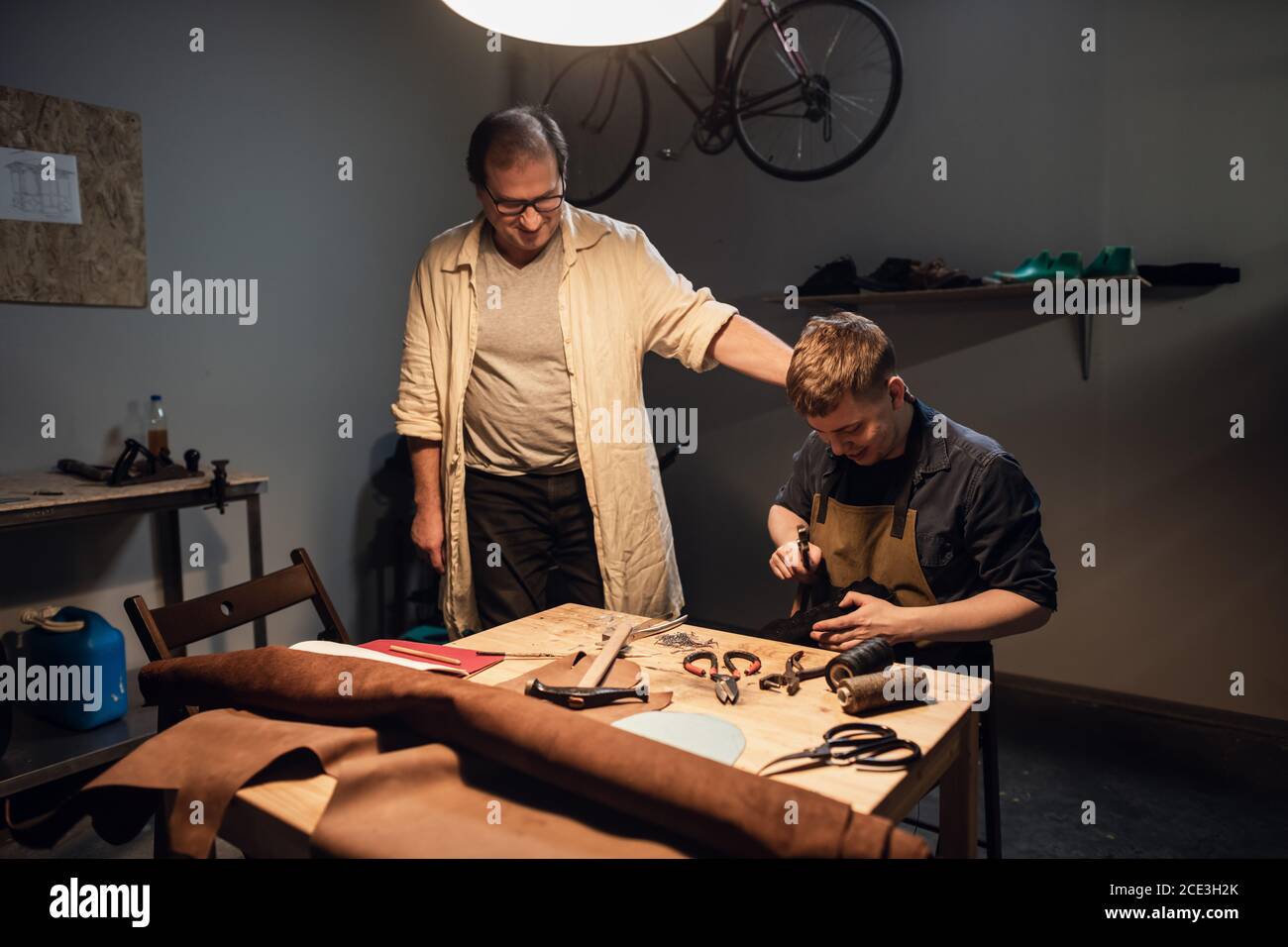 a father-shoemaker passes on to his son the experience of hand-making ...