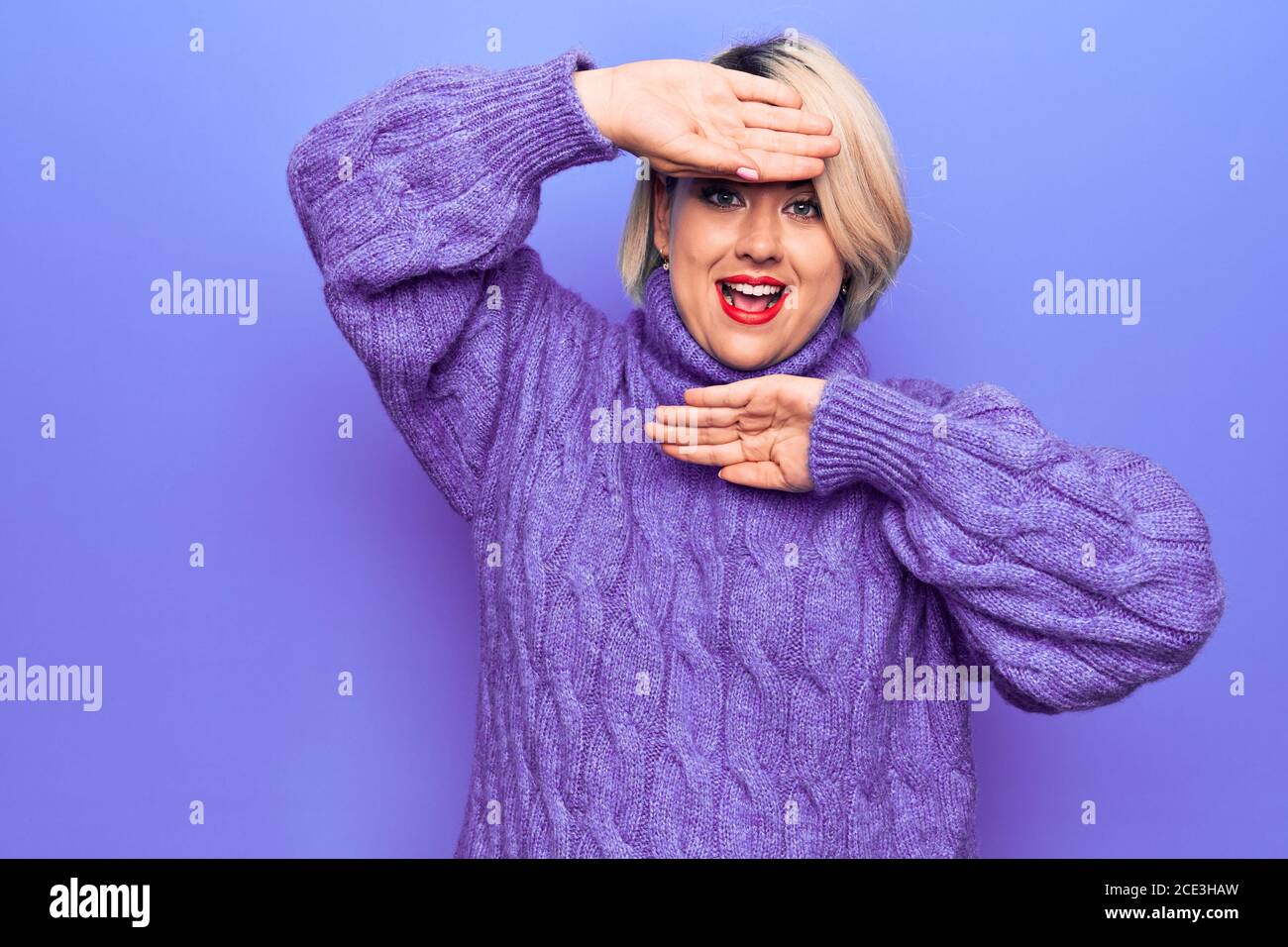 Beautiful blonde plus size woman wearing casual turtleneck sweater over ...