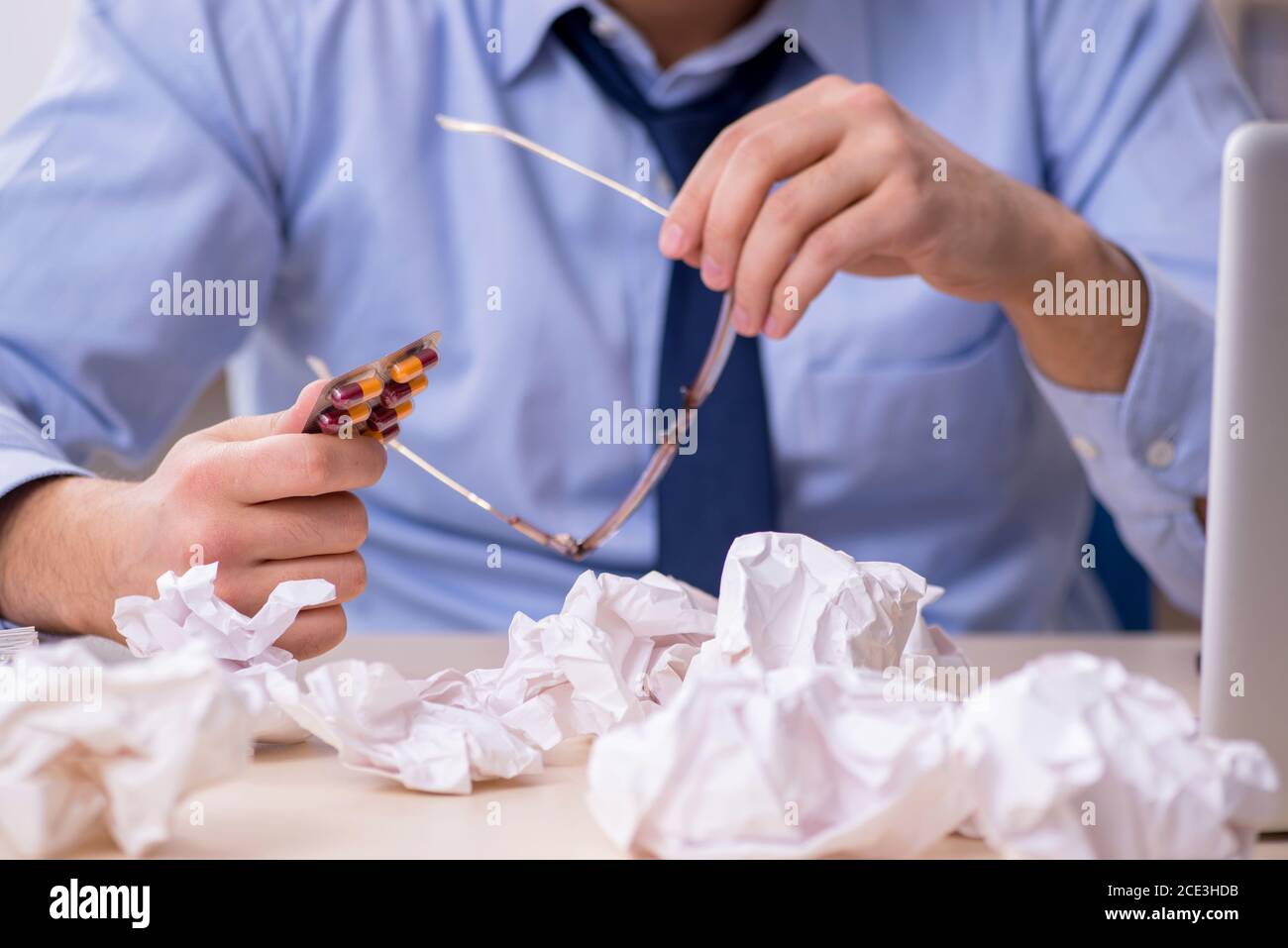 Sick male employee suffering at the workplace Stock Photo - Alamy