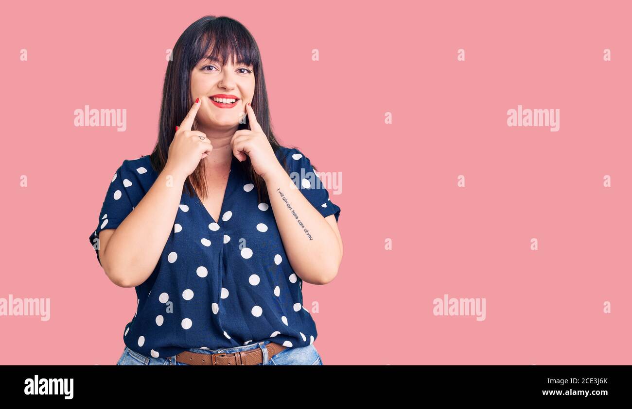 Young plus size woman wearing casual clothes smiling with open mouth ...