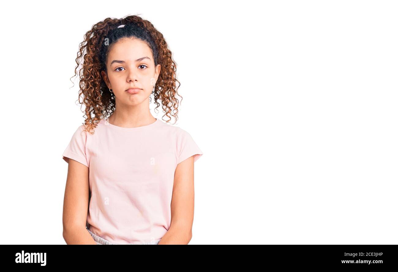 Beautiful kid girl with curly hair wearing casual clothes depressed and ...