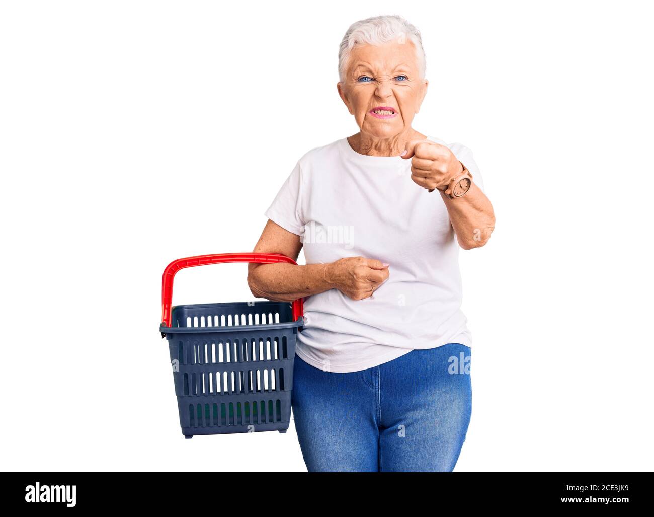 Senior beautiful woman with blue eyes and grey hair holding supermarket ...