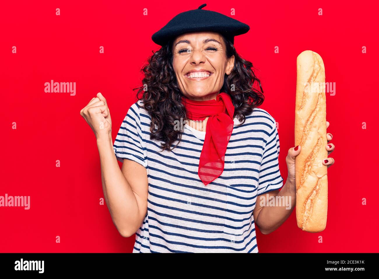 Middle age beautiful woman wearing french beret holding baguette ...