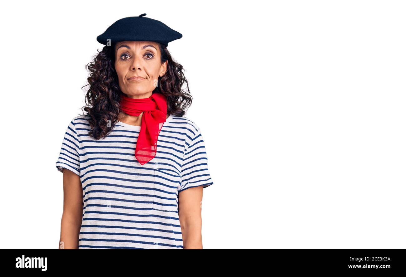Middle age beautiful woman wearing french beret and scarf with serious ...