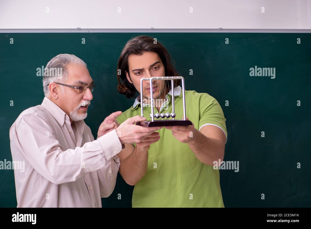 Old professor physicist and student in the classroom Stock Photo - Alamy