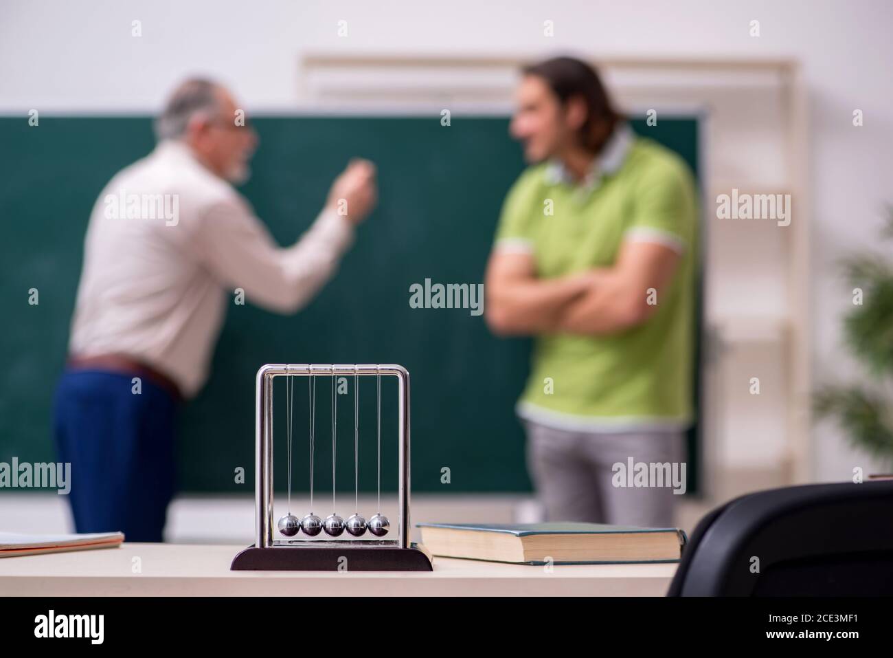 Old professor physicist and student in the classroom Stock Photo - Alamy
