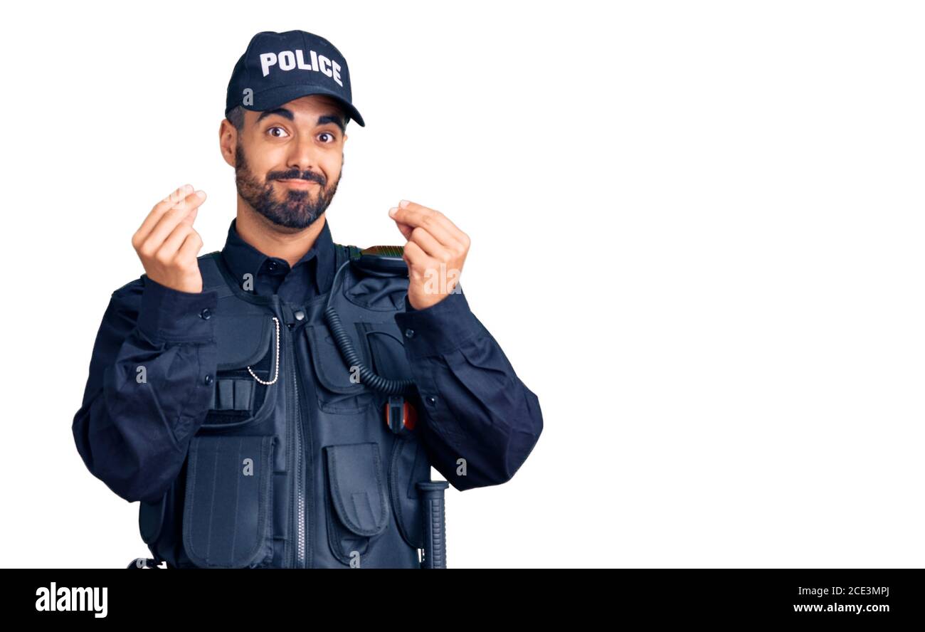 Young hispanic man wearing police uniform doing money gesture with ...