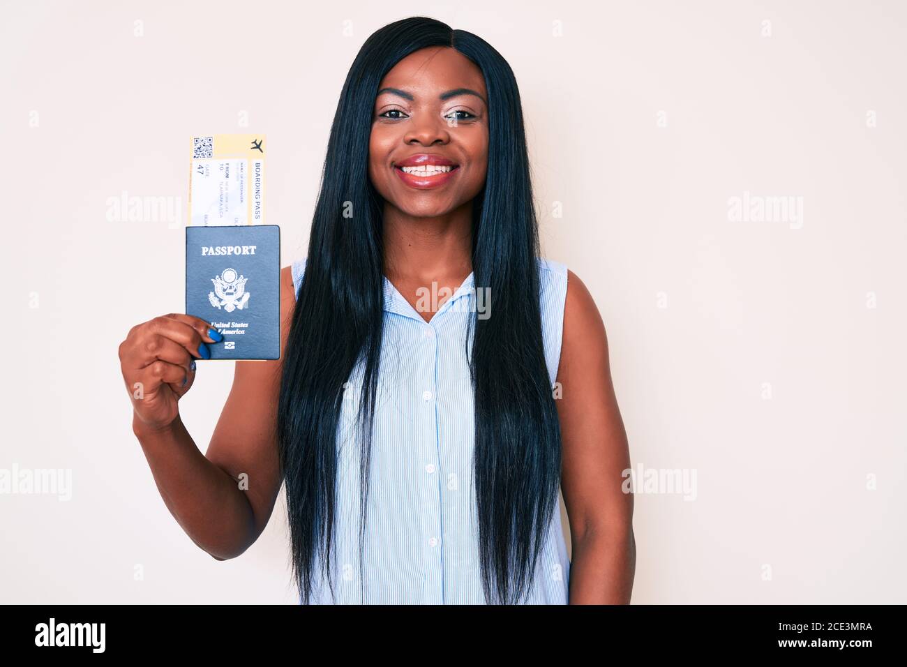 Young african american woman holding united states passport looking ...
