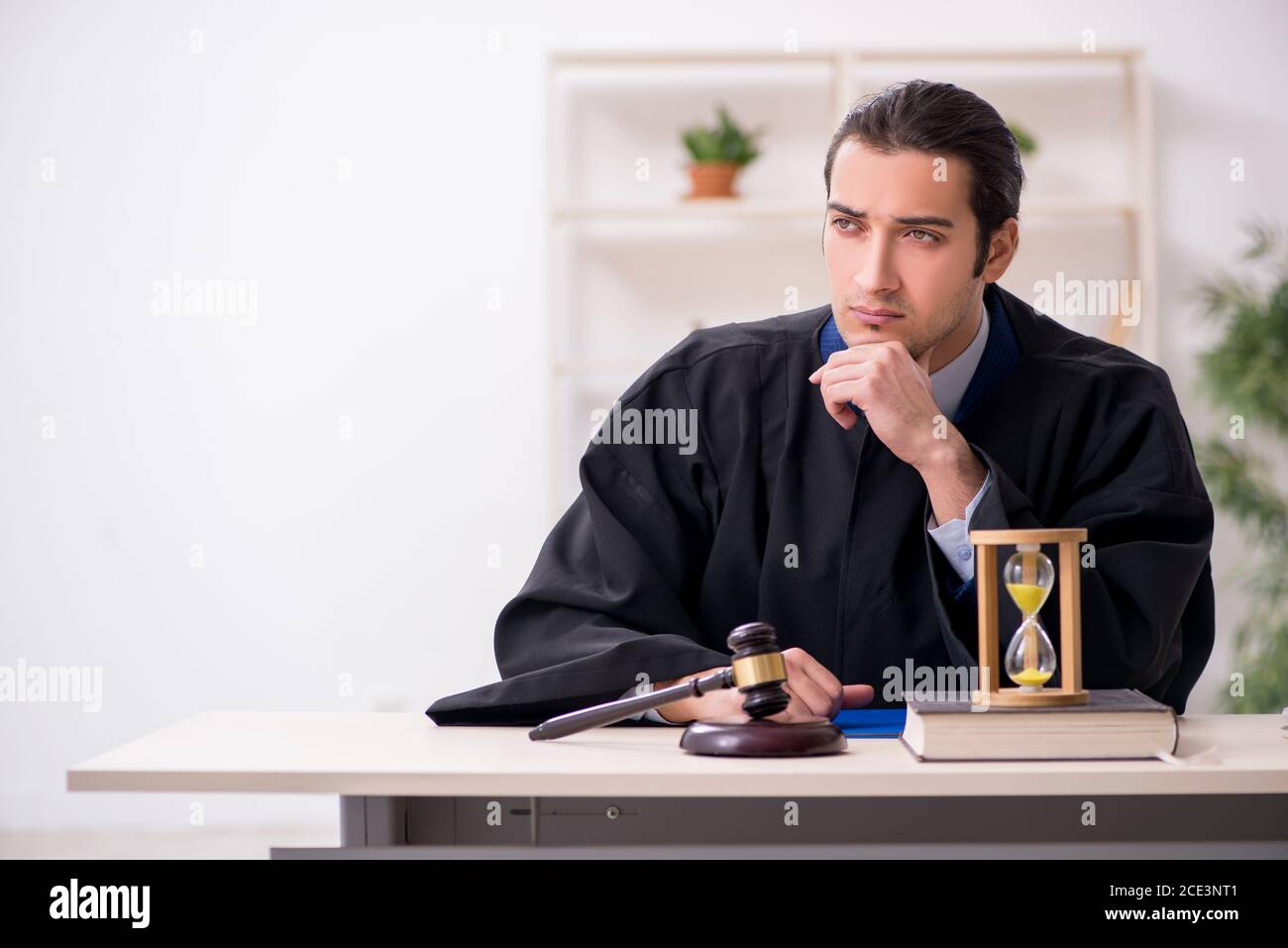 Young judge in time management concept Stock Photo - Alamy