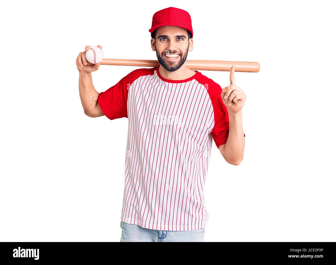 Young handsome man with beard playing baseball holding bat and ball ...