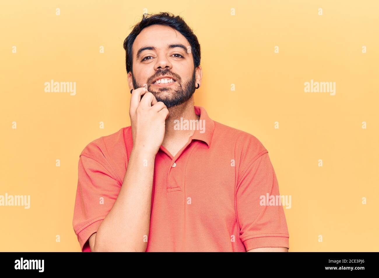 Young hispanic man wearing casual clothes smiling looking confident at ...