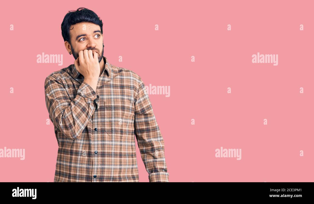 Young hispanic man wearing casual clothes looking stressed and nervous ...