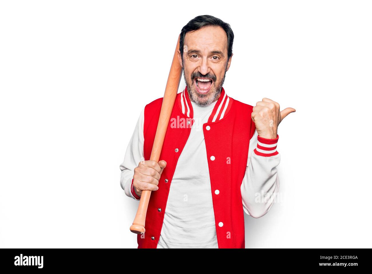 Middle age handsome sporty man wearing jacket playing baseball using ...