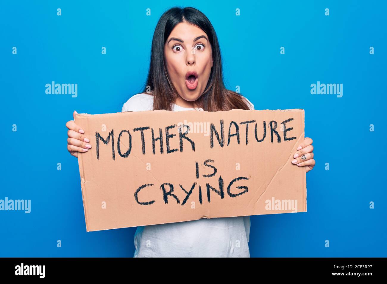 Young woman asking for environment care holding banner with mother ...