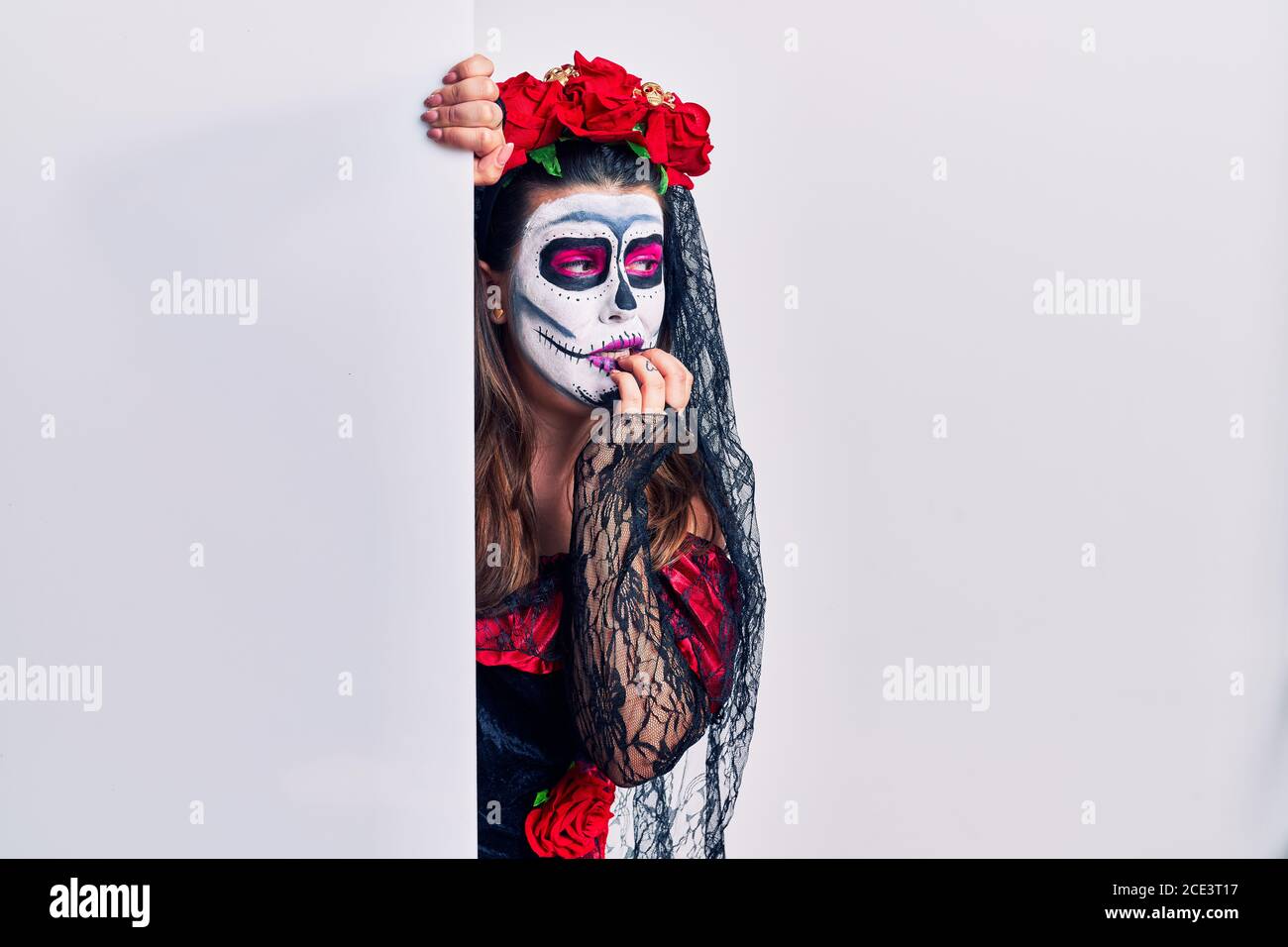 Young Woman Wearing Day Of The Dead Custome Holding Blank Empty Banner Looking Stressed And