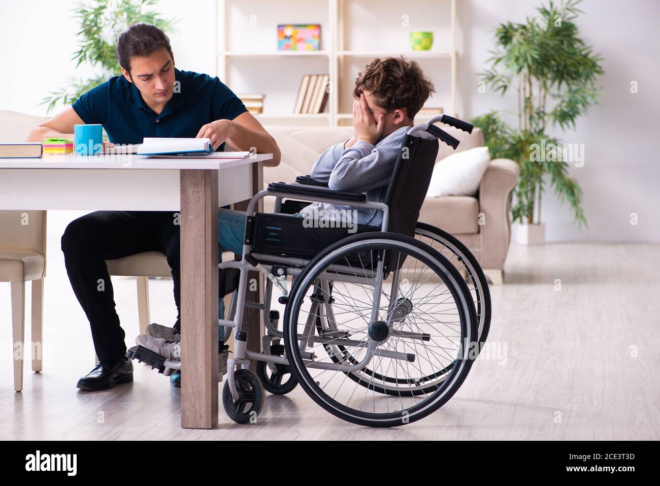 Father and disabled son in the education concept Stock Photo - Alamy