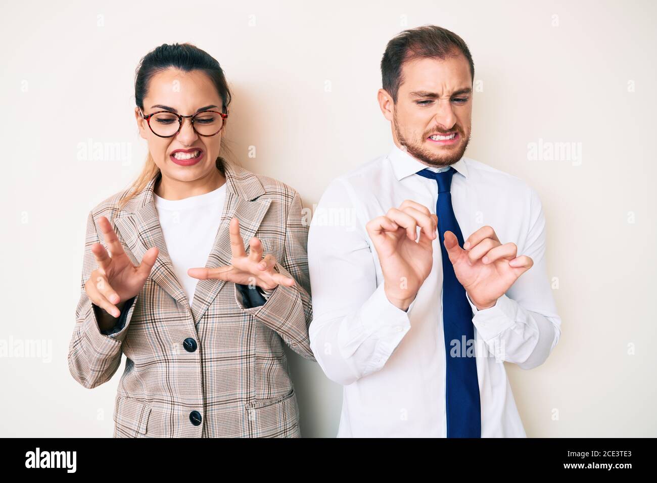 Beautiful couple wearing business clothes disgusted expression ...