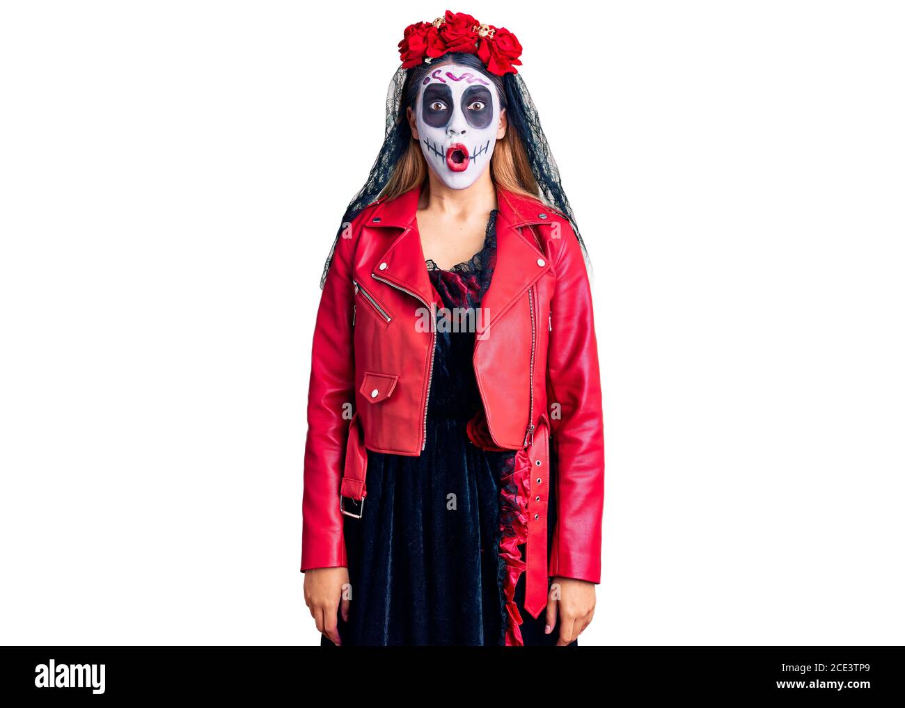 Woman wearing day of the dead costume over background afraid and ...