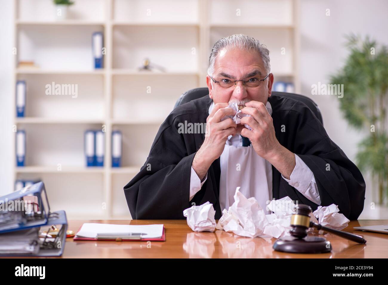 Old male judge working in the courthouse Stock Photo - Alamy